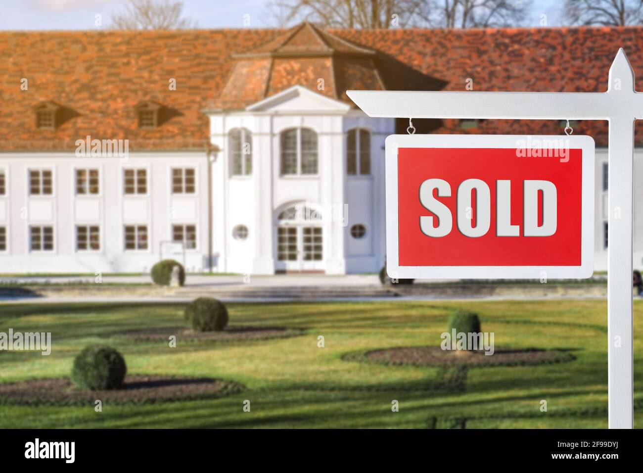 Sign board with text SOLD near old building on city street Stock Photo ...