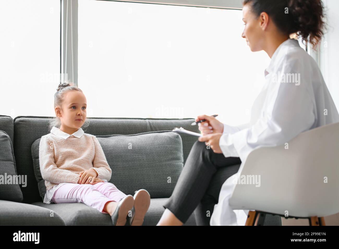 Female psychologist working with little girl in office Stock Photo - Alamy