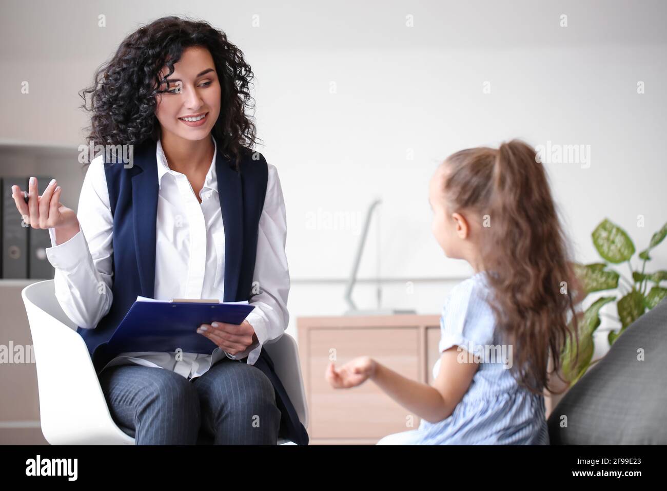 Female psychologist working with little girl in office Stock Photo - Alamy
