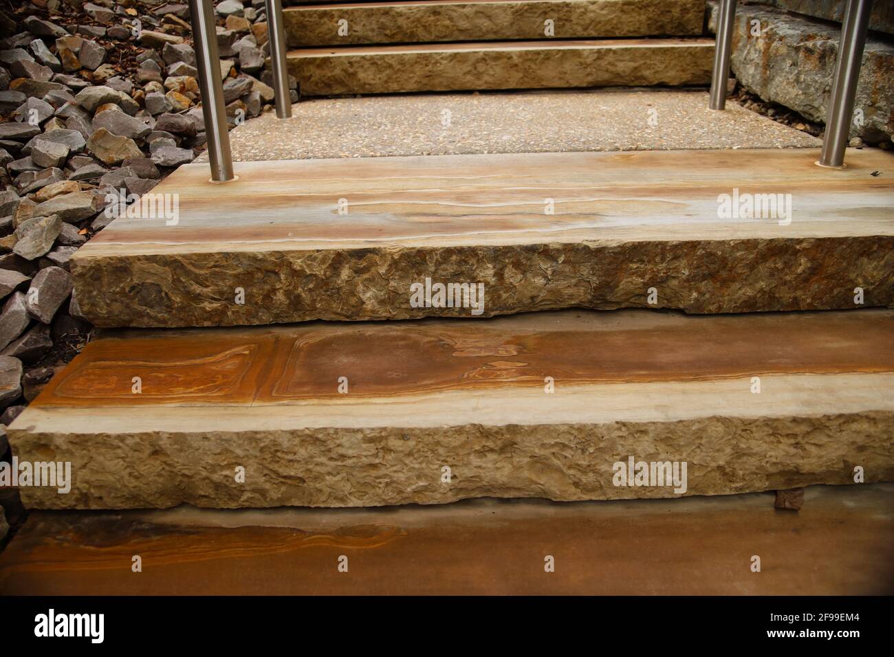 Closeup of rock stairs with railings in The Gathering Place park in ...