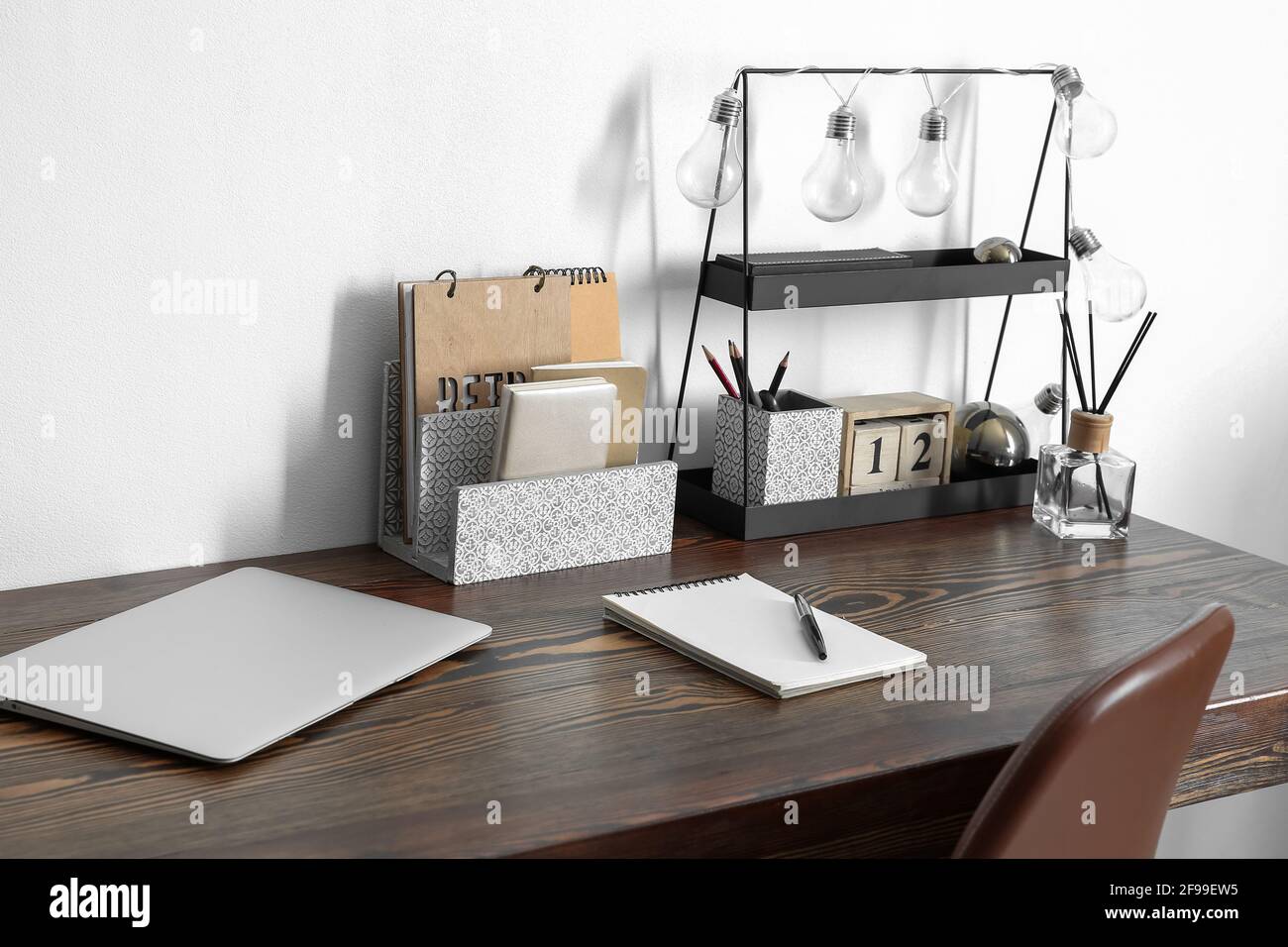 Modern workplace with organizer and laptop in room Stock Photo - Alamy