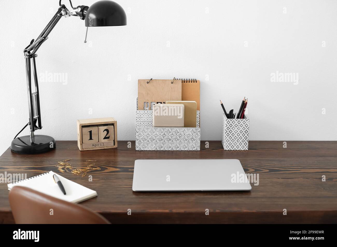 Modern workplace with organizer and laptop in room Stock Photo - Alamy