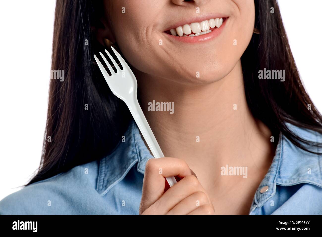 Beautiful young woman with plastic fork on white background Stock Photo ...