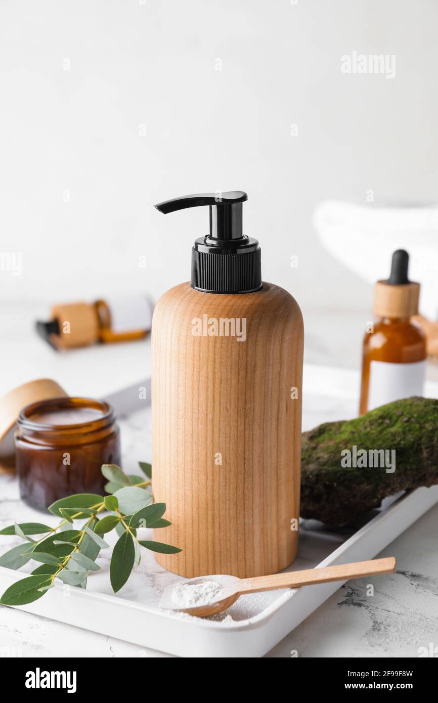 Bottle with natural shampoo on light background Stock Photo - Alamy
