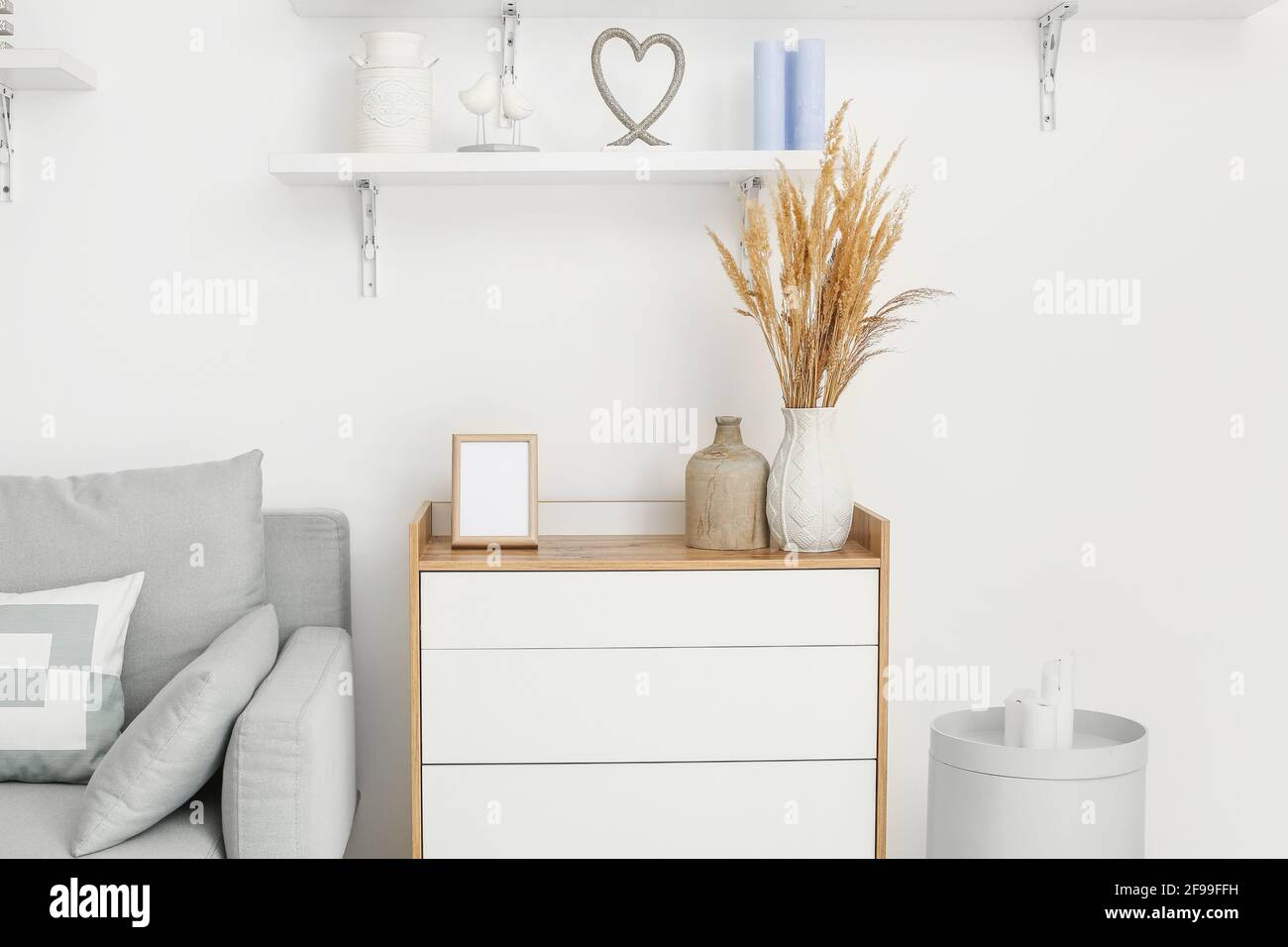 Modern living room with chest of drawers and sofa Stock Photo - Alamy