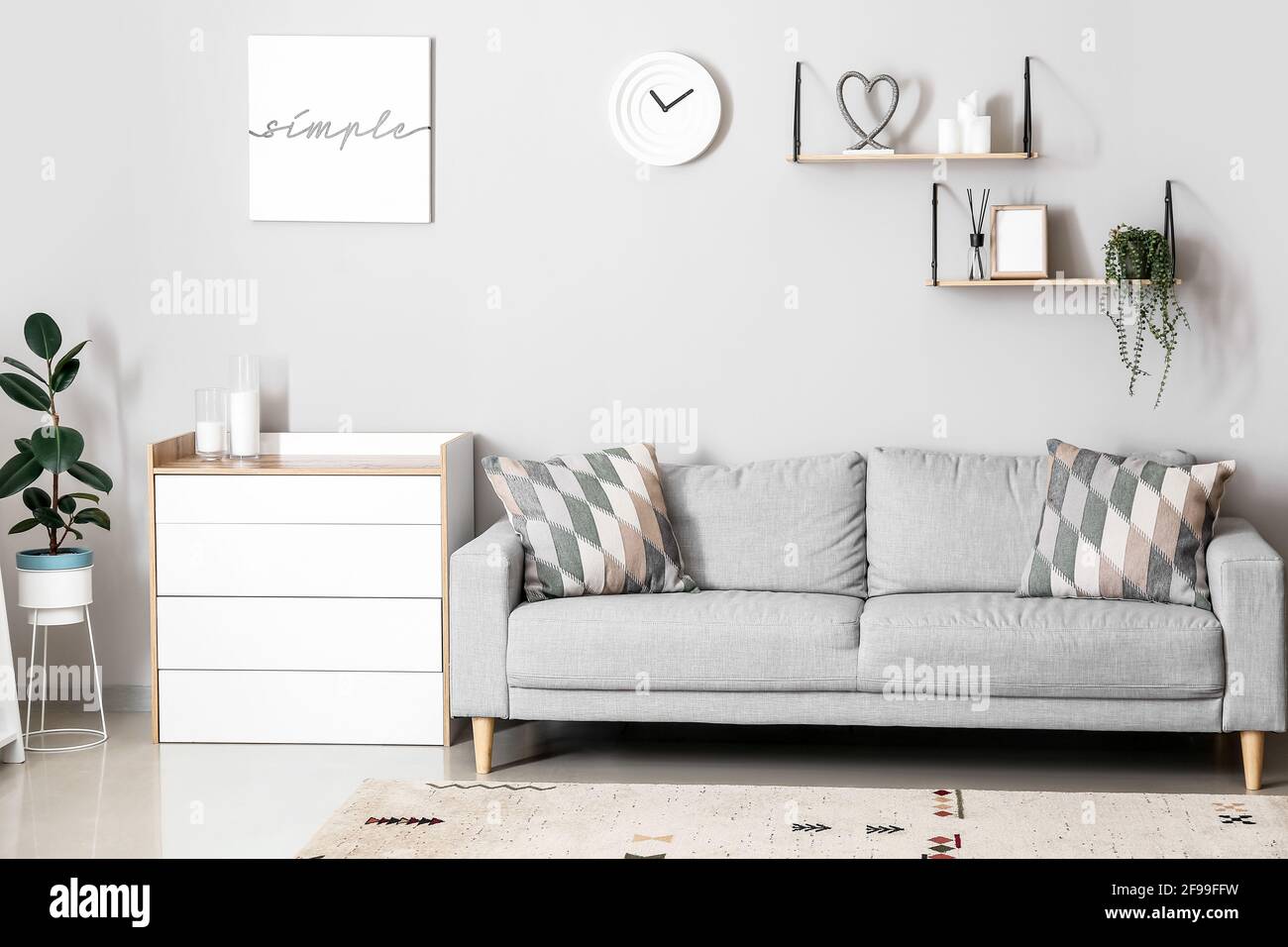 Modern living room with chest of drawers and sofa Stock Photo - Alamy