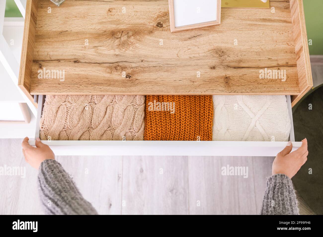 Woman opening drawer with clothes at home Stock Photo - Alamy