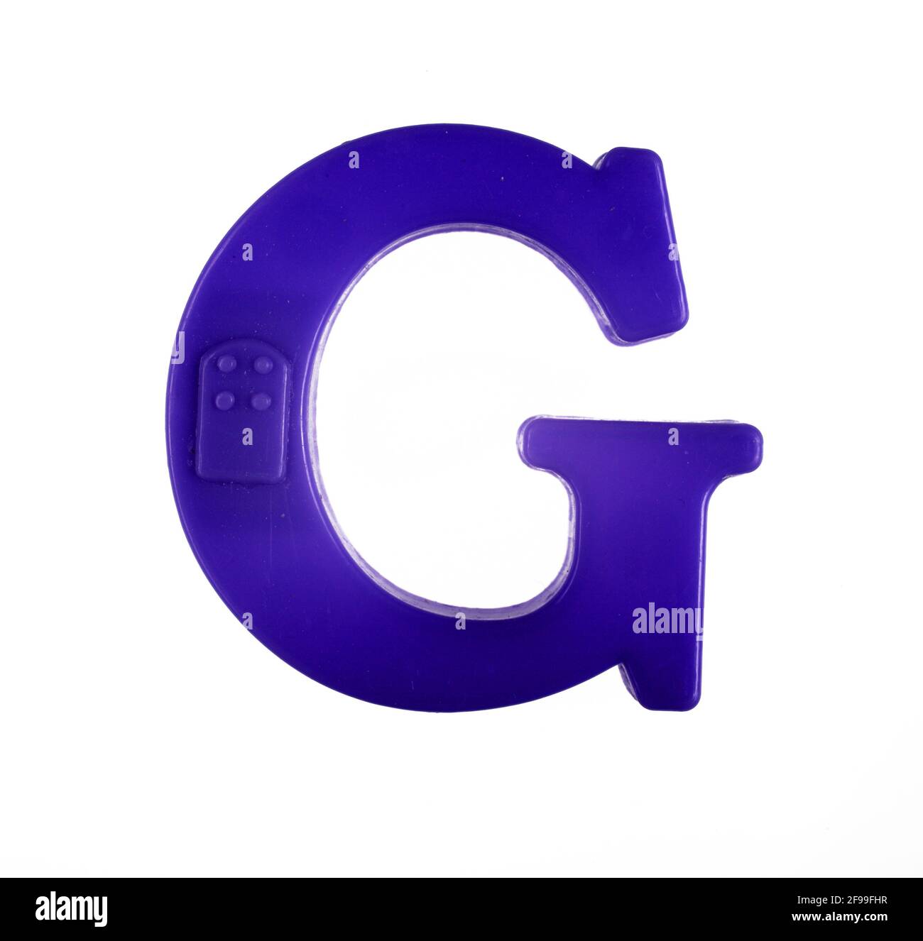 Plastic letter G of the English alphabet against white background, top ...