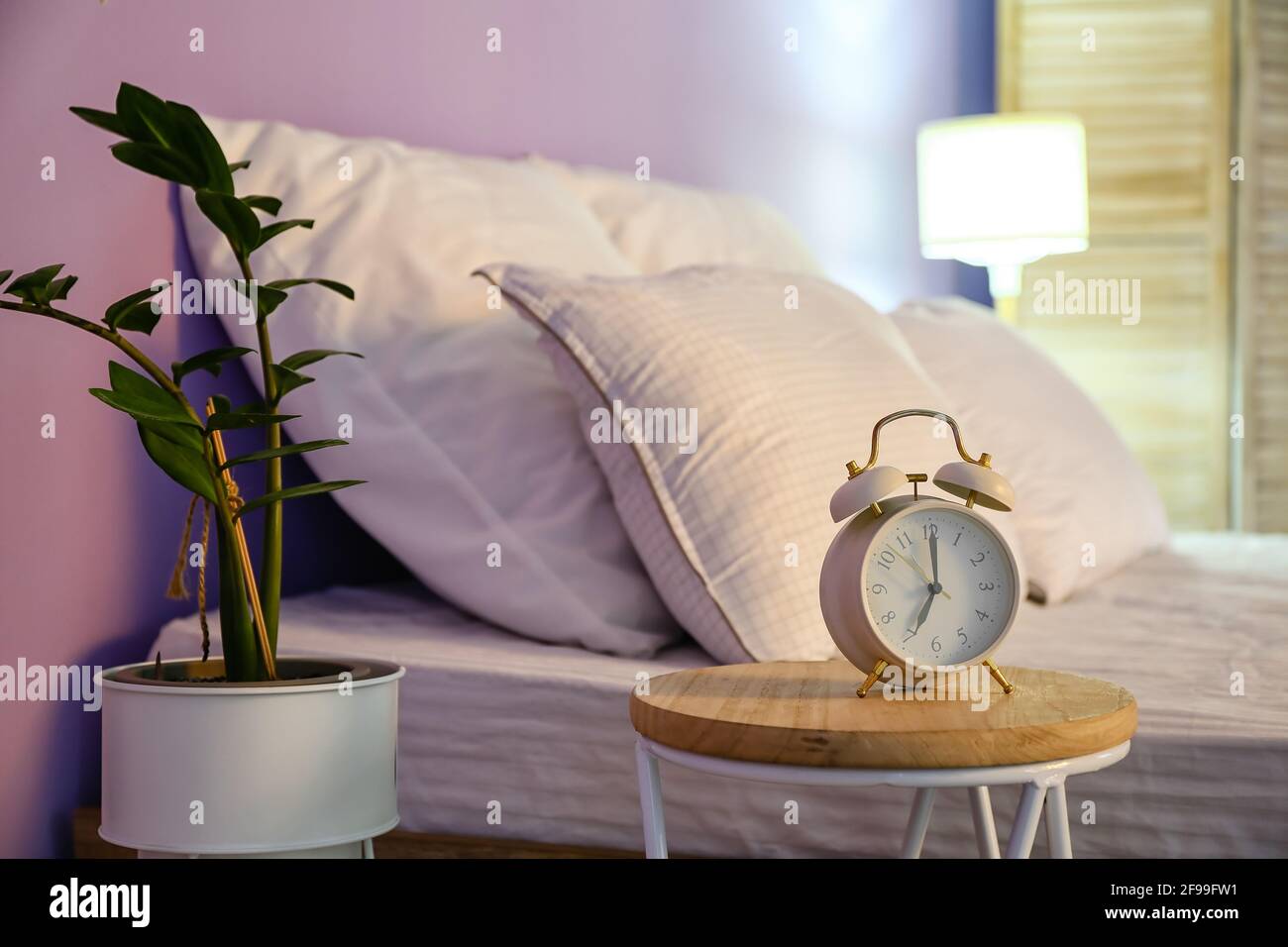 Alarm clock on table in bedroom Stock Photo - Alamy