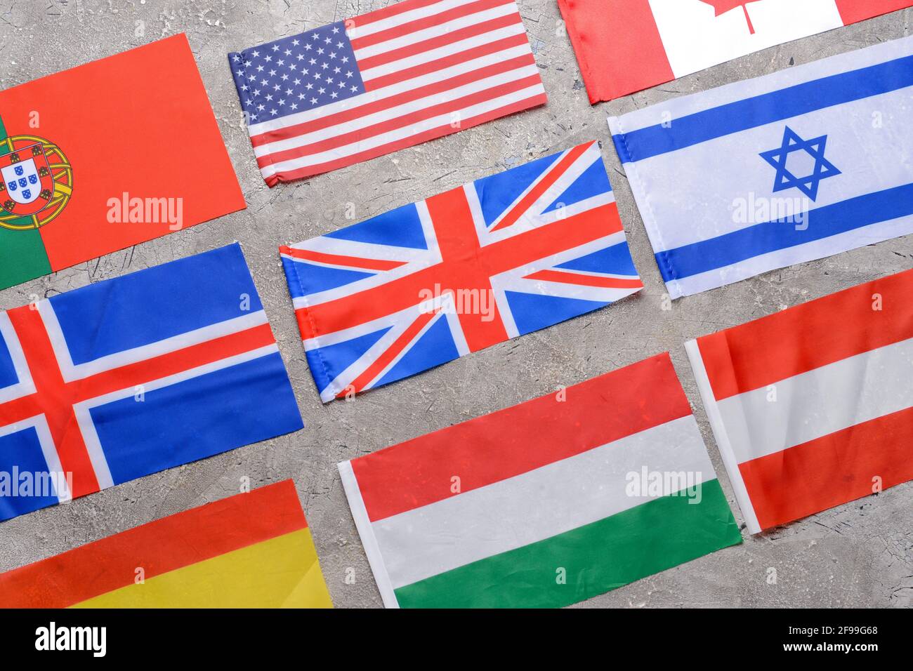 Different flags on grey background Stock Photo - Alamy