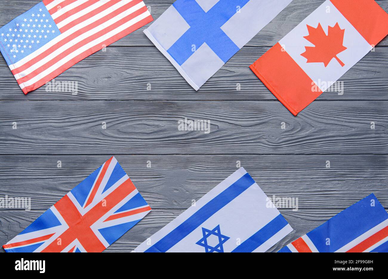 Different flags on wooden background Stock Photo - Alamy