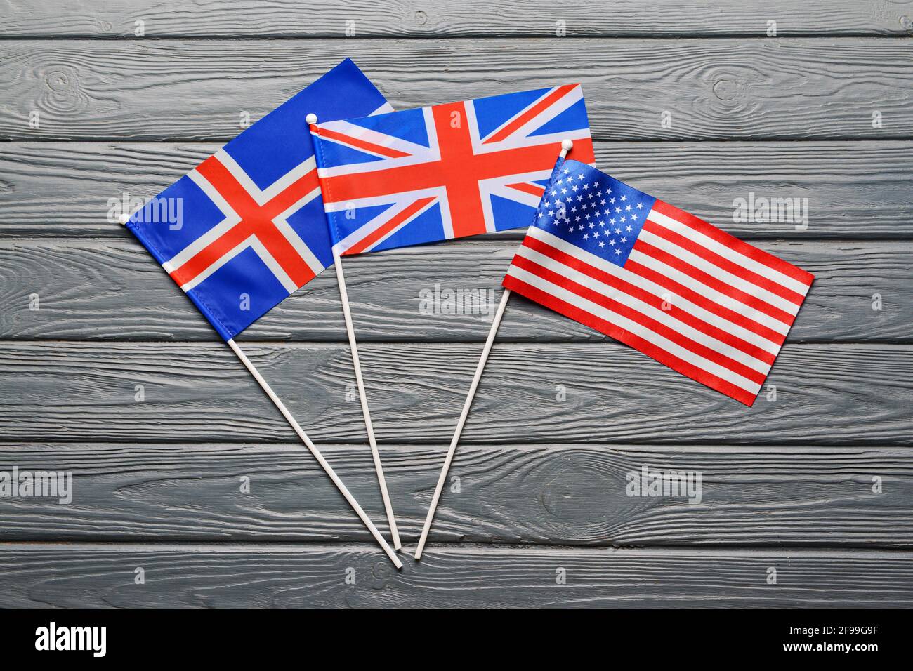 Different flags on wooden background Stock Photo - Alamy