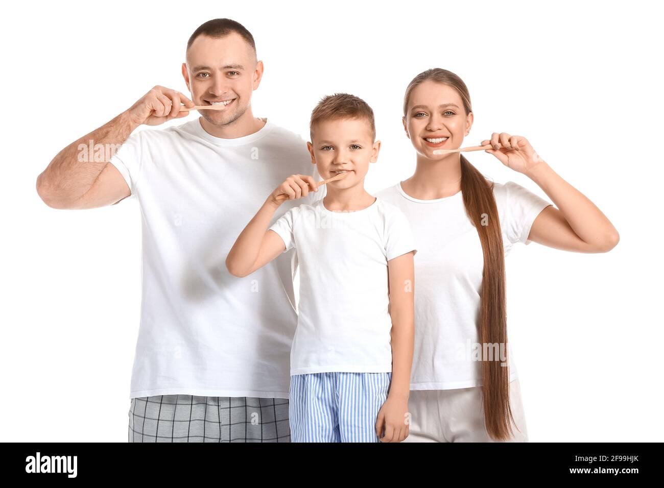 Happy family brushing teeth on white background Stock Photo - Alamy