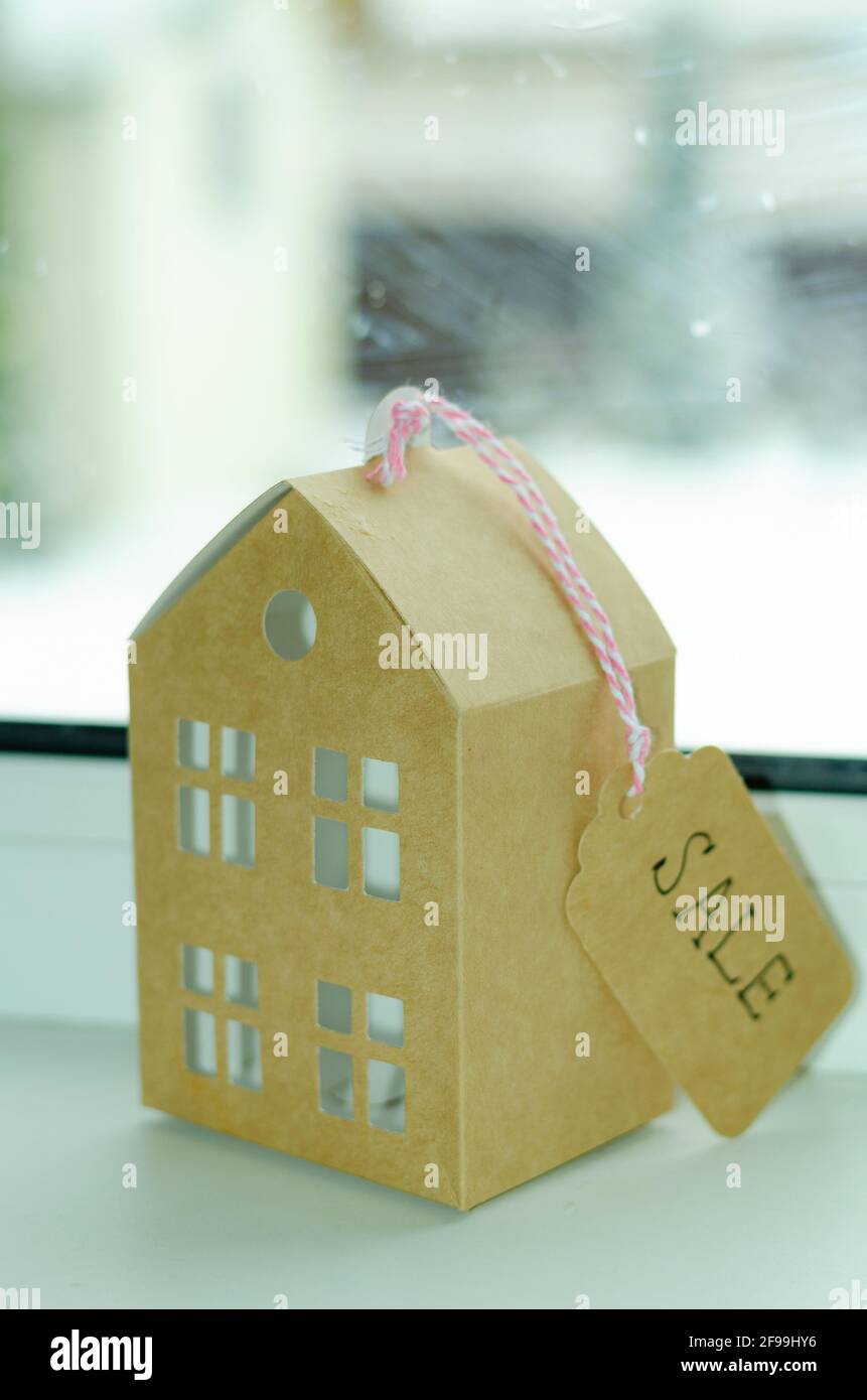 Real estate sale concept, paper model of residential building. Studio ...