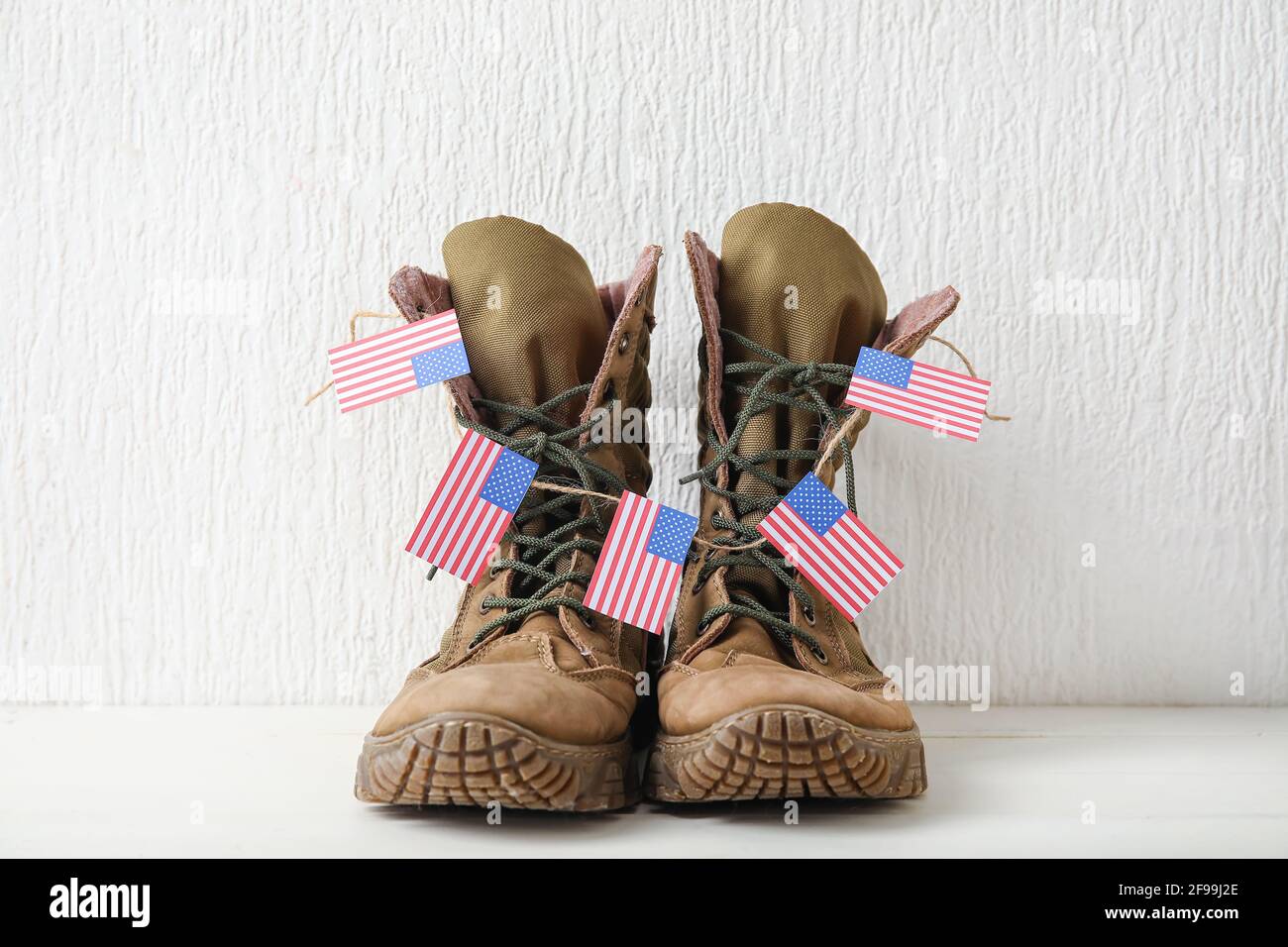 Military boots with USA flags on white background Stock Photo - Alamy