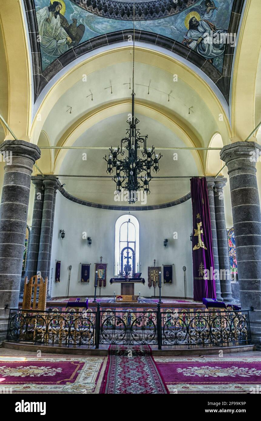 Vertical shot of a church altar and apse with religious painting on the ...