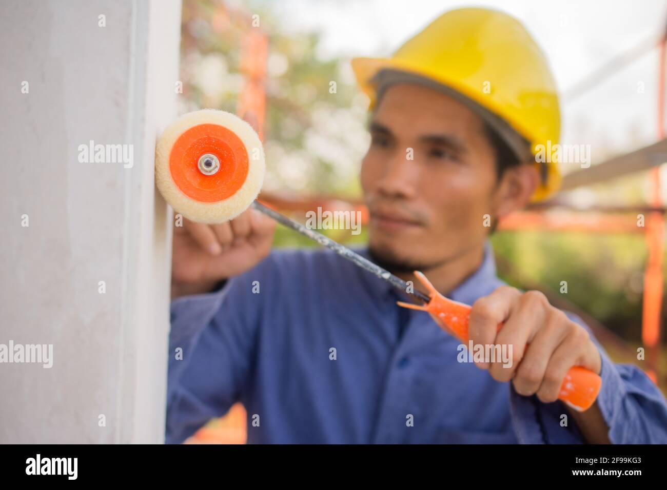 Painter is painting the house, Man use Roller paint on wall Stock Photo ...