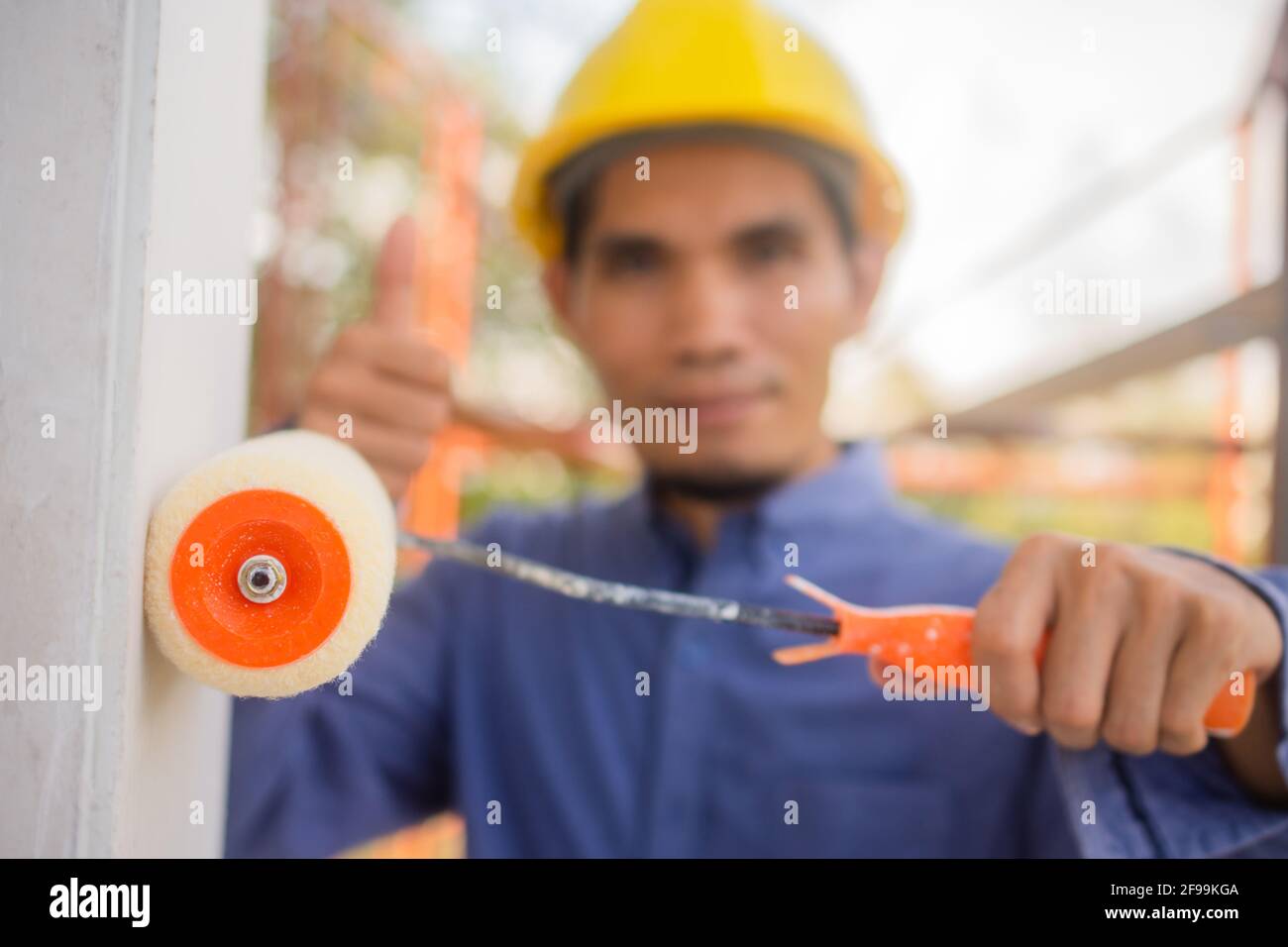 Painter is painting the house, Man use Roller paint on wall Stock Photo ...