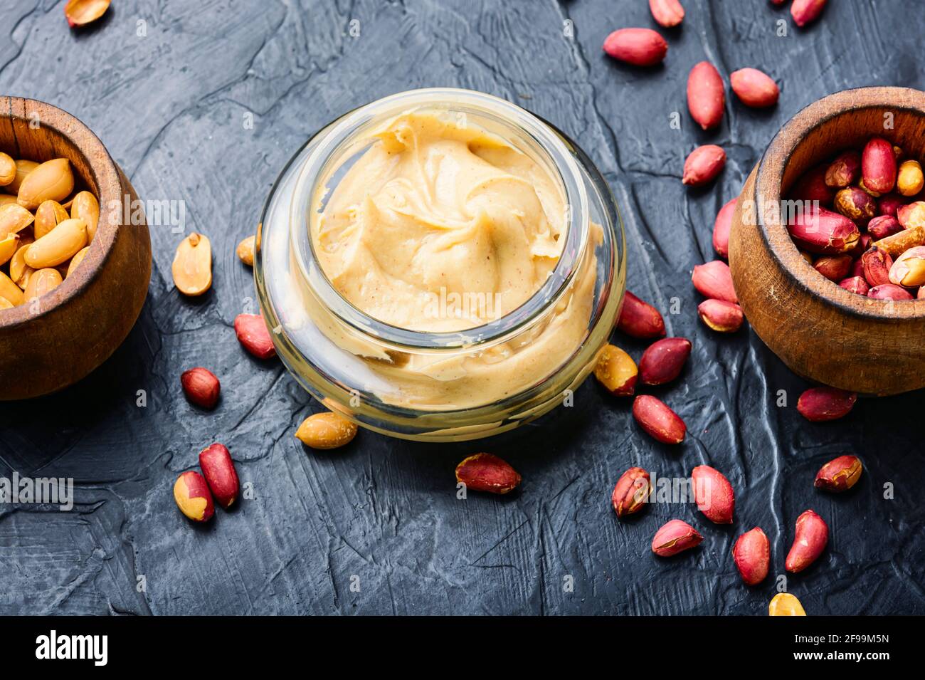 Peanut paste and heap of nuts in glass jar.Peanut butter in bowl Stock Photo - Alamy