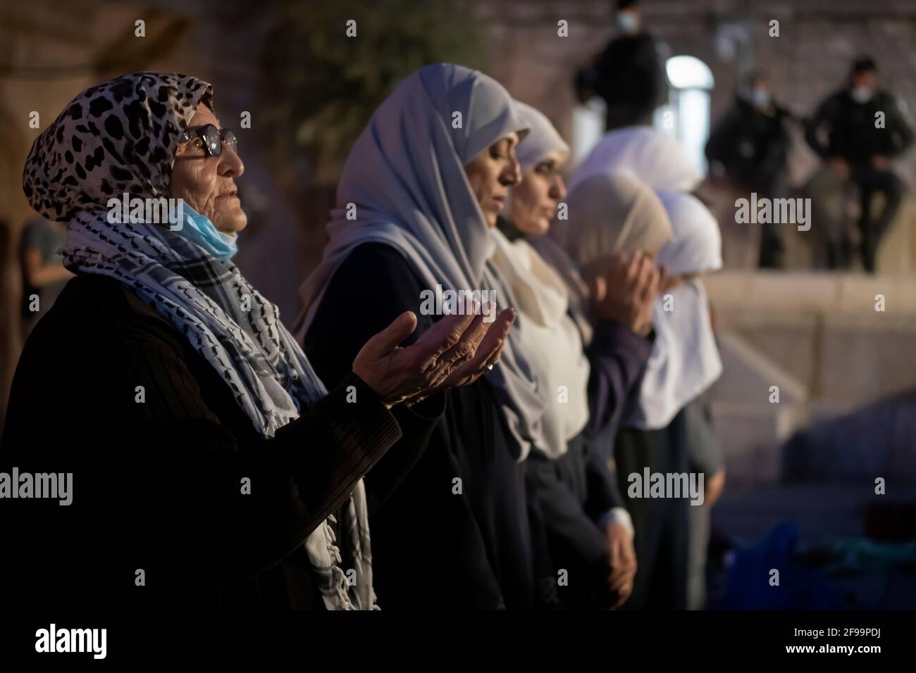 Israeli border police watch over as Palestinian worshipers perform the ...