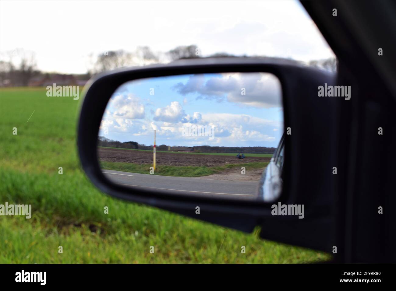 The landscape is reflected in the exterior mirror of a car Stock Photo ...