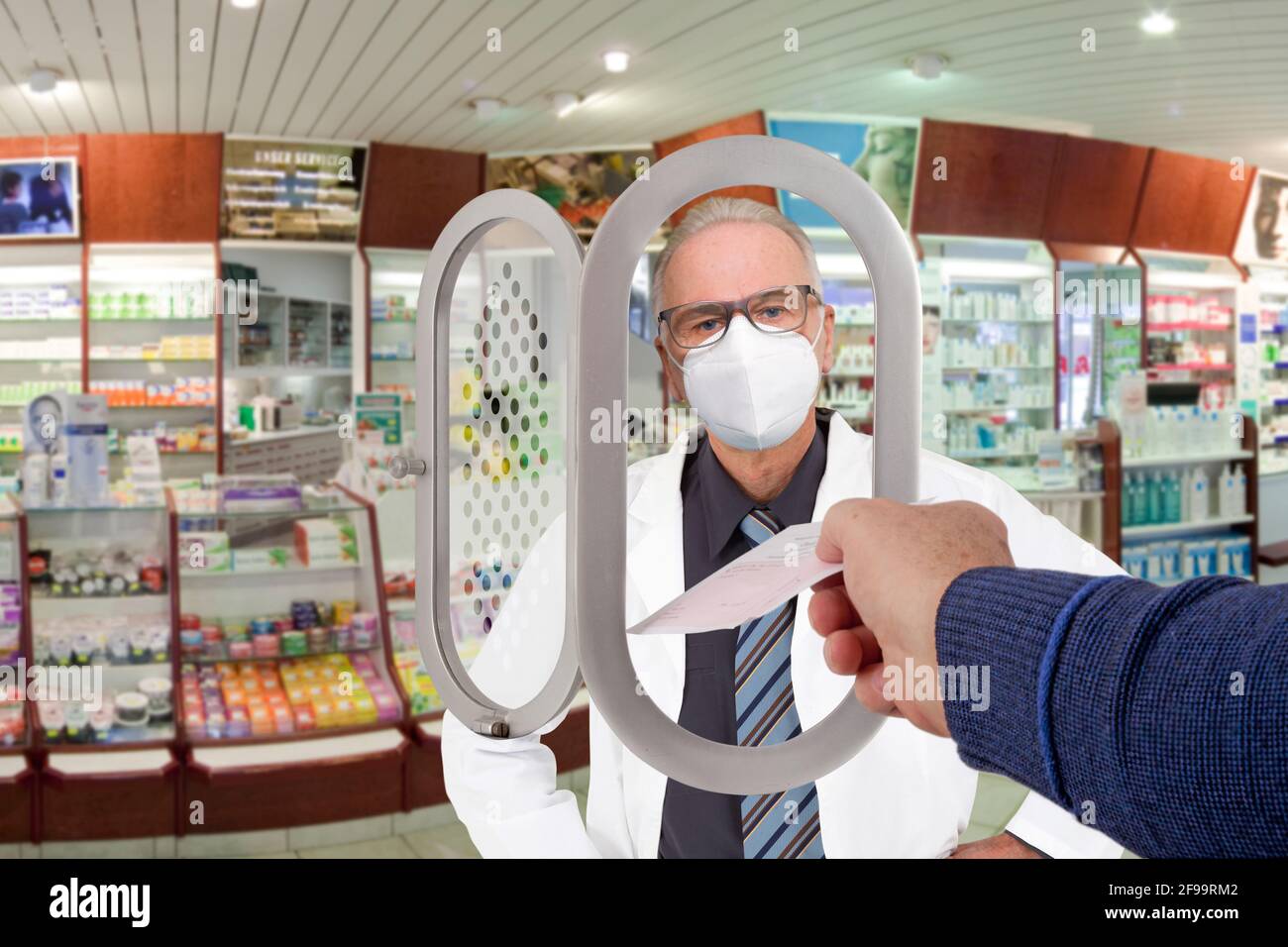 Pharmacist with face mask takes a prescription Stock Photo - Alamy
