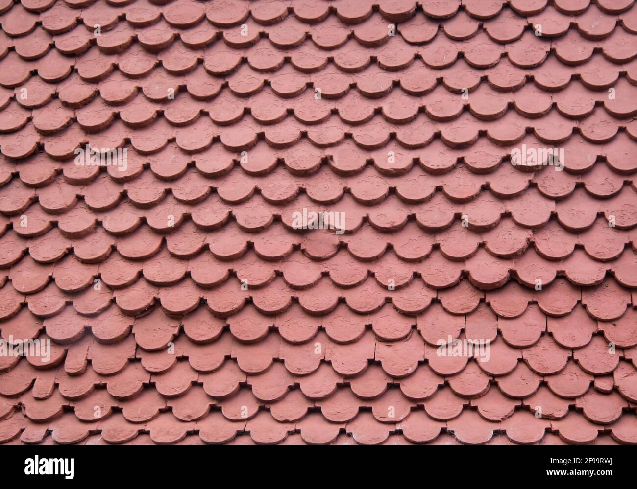 Clay wall shingles in repeating pattern on historic building exterior ...