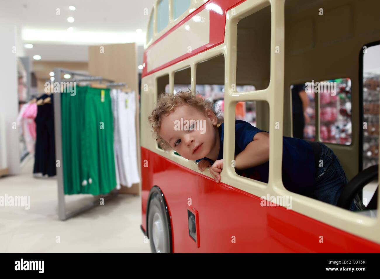Child in a little bus at playground Stock Photo - Alamy