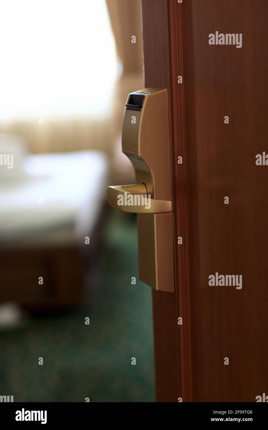 Open wooden door of the hotel room Stock Photo - Alamy