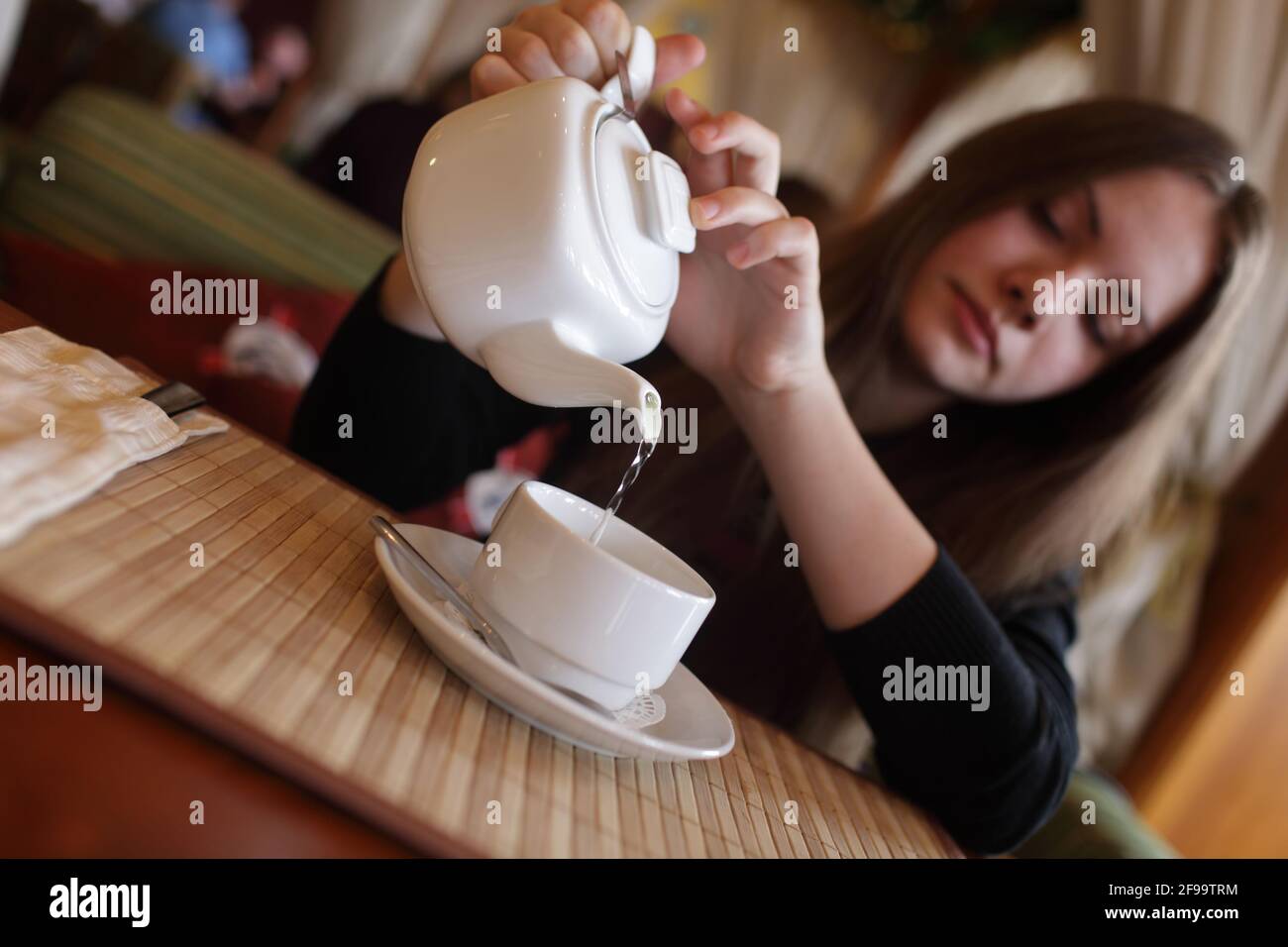 Teen is pouring green tea in a restaurant Stock Photo - Alamy