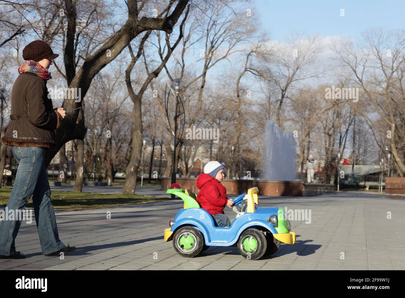 Woman controls the car with child using remote control Stock Photo - Alamy
