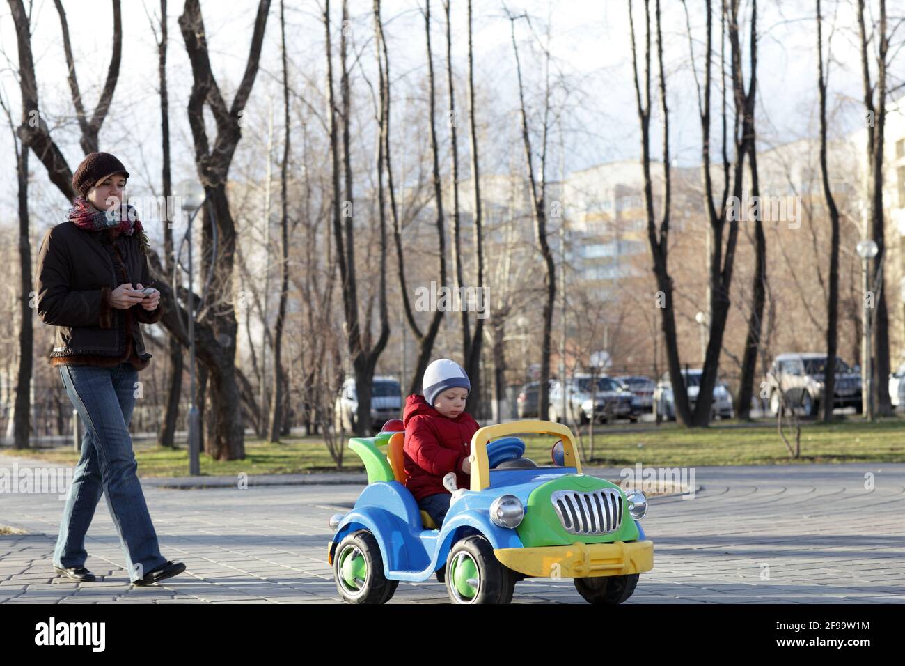 Girl controls the car with child using remote control Stock Photo - Alamy