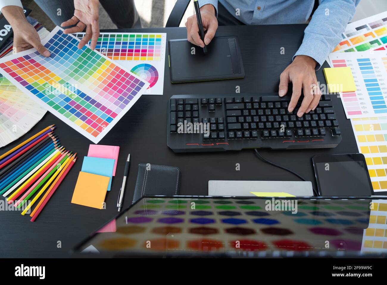 graphic designer team working on web design using color swatches ...