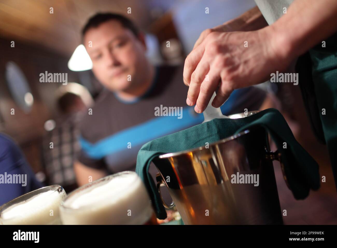 Waiter opens a bottle of vodka in a pub Stock Photo - Alamy