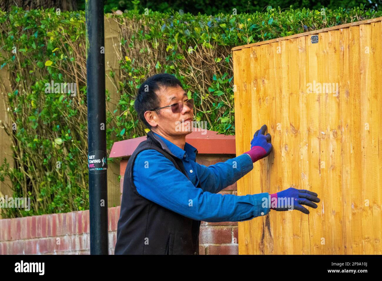 A man installing security fencing at the official residence of the ...