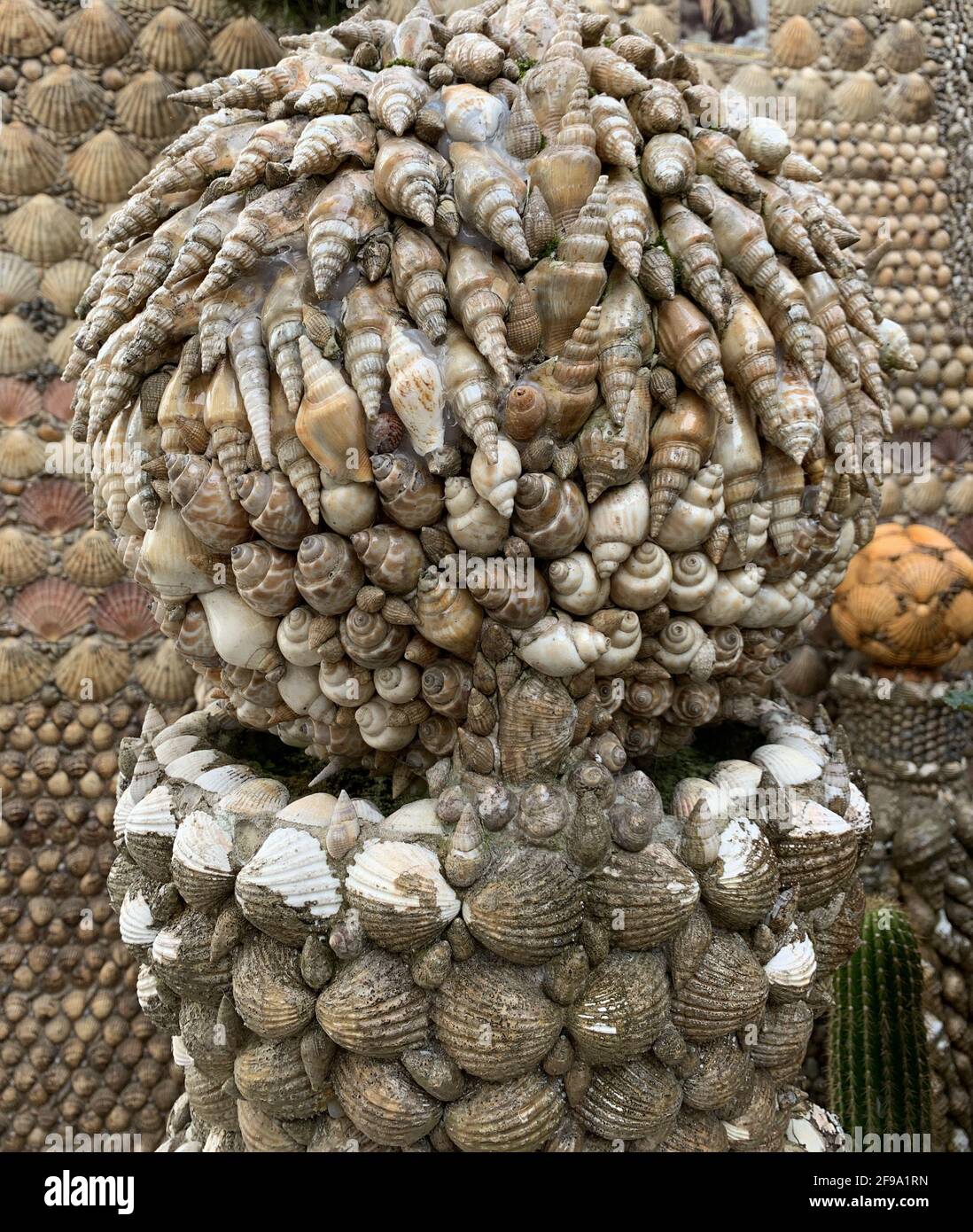 Vertical shot of decorative shells in a concrete post Stock Photo - Alamy