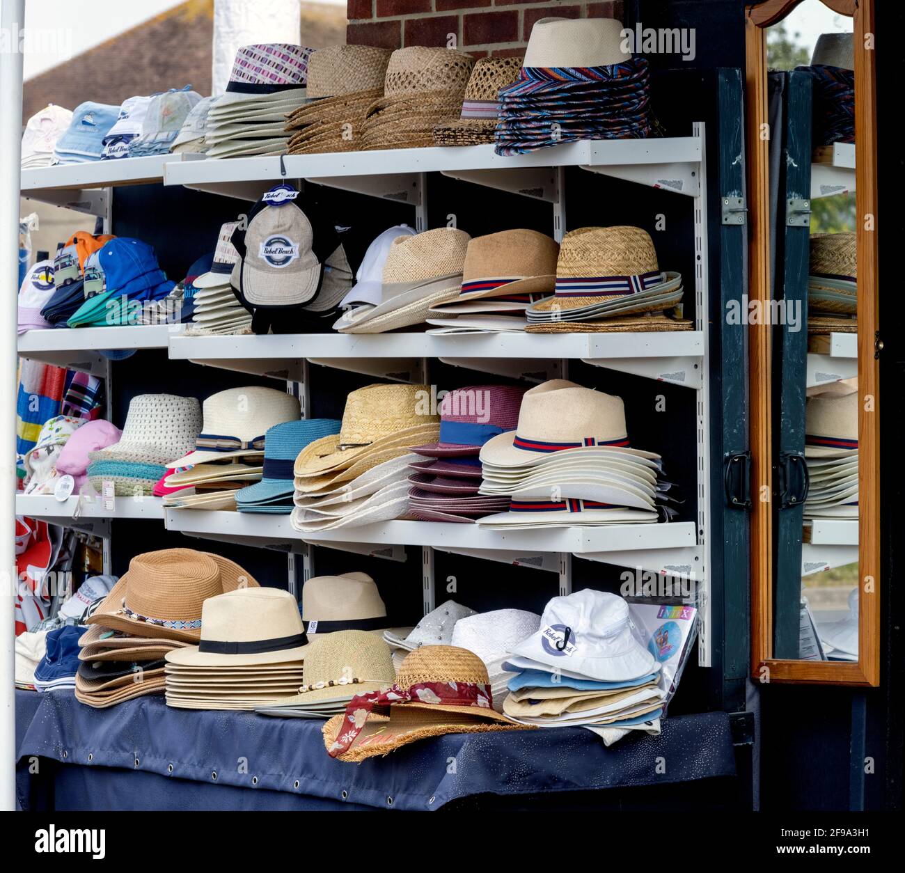 Display of sun hats for sale ay seaside shop at Pagham, West Sussex ...