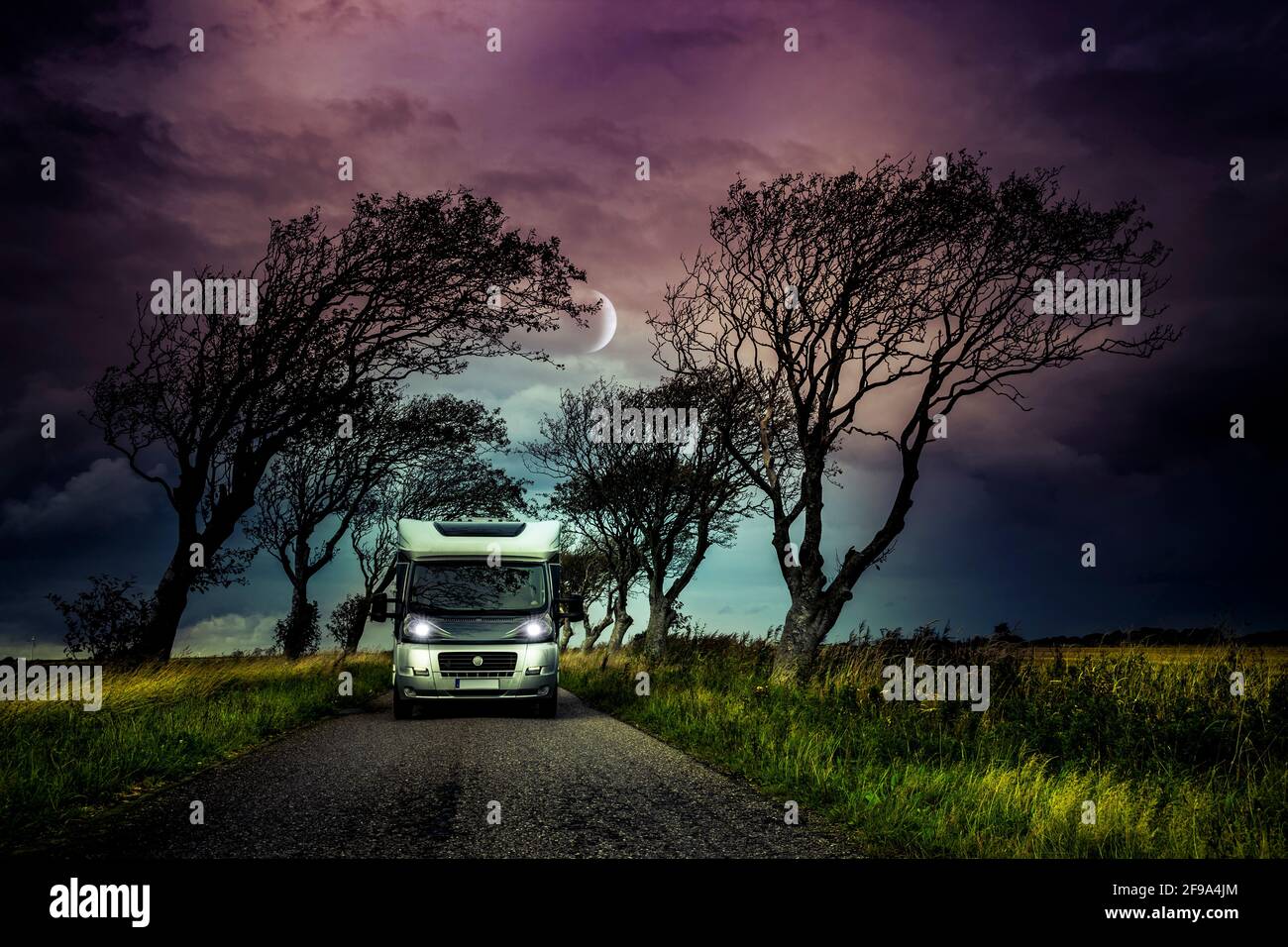 Motorhome on a narrow country road with trees Stock Photo - Alamy