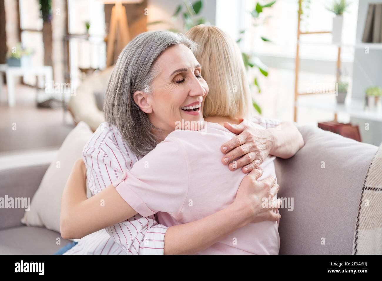 Photo of happy charming cheerful young woman and old lady hug love ...