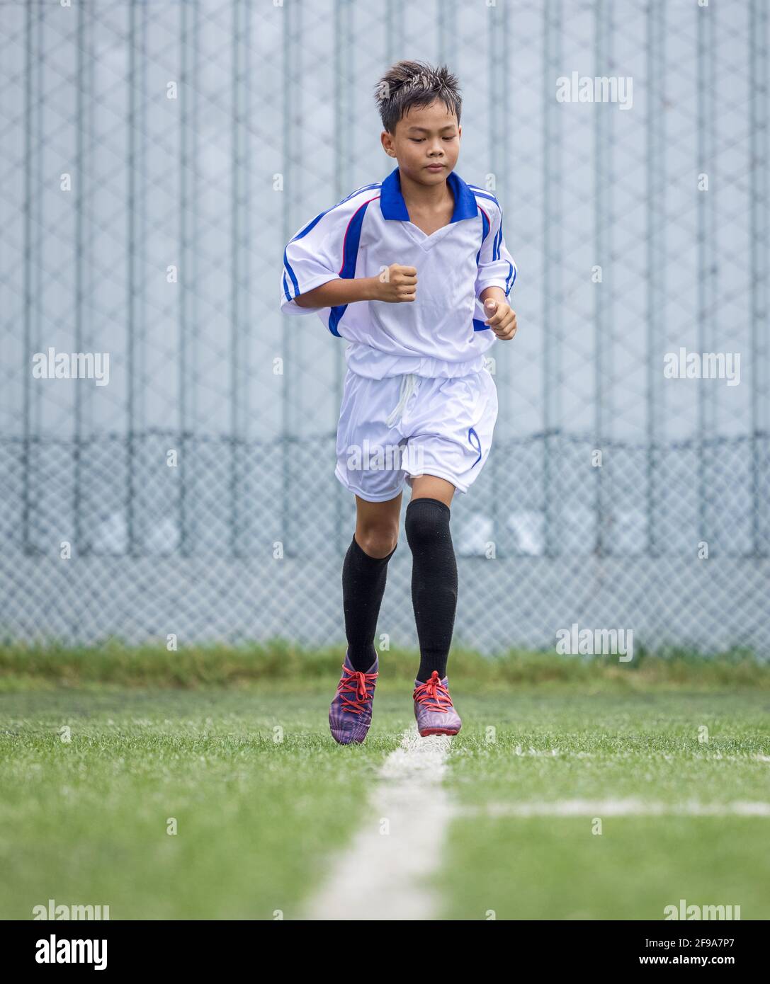 Boy Football Player training session running exercise for Children ...