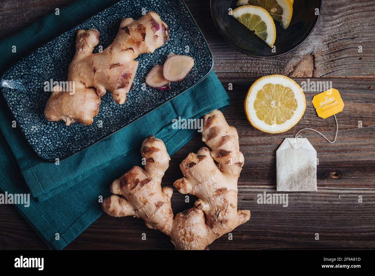 Healthy fresh raw ginger roots with lemon Stock Photo - Alamy