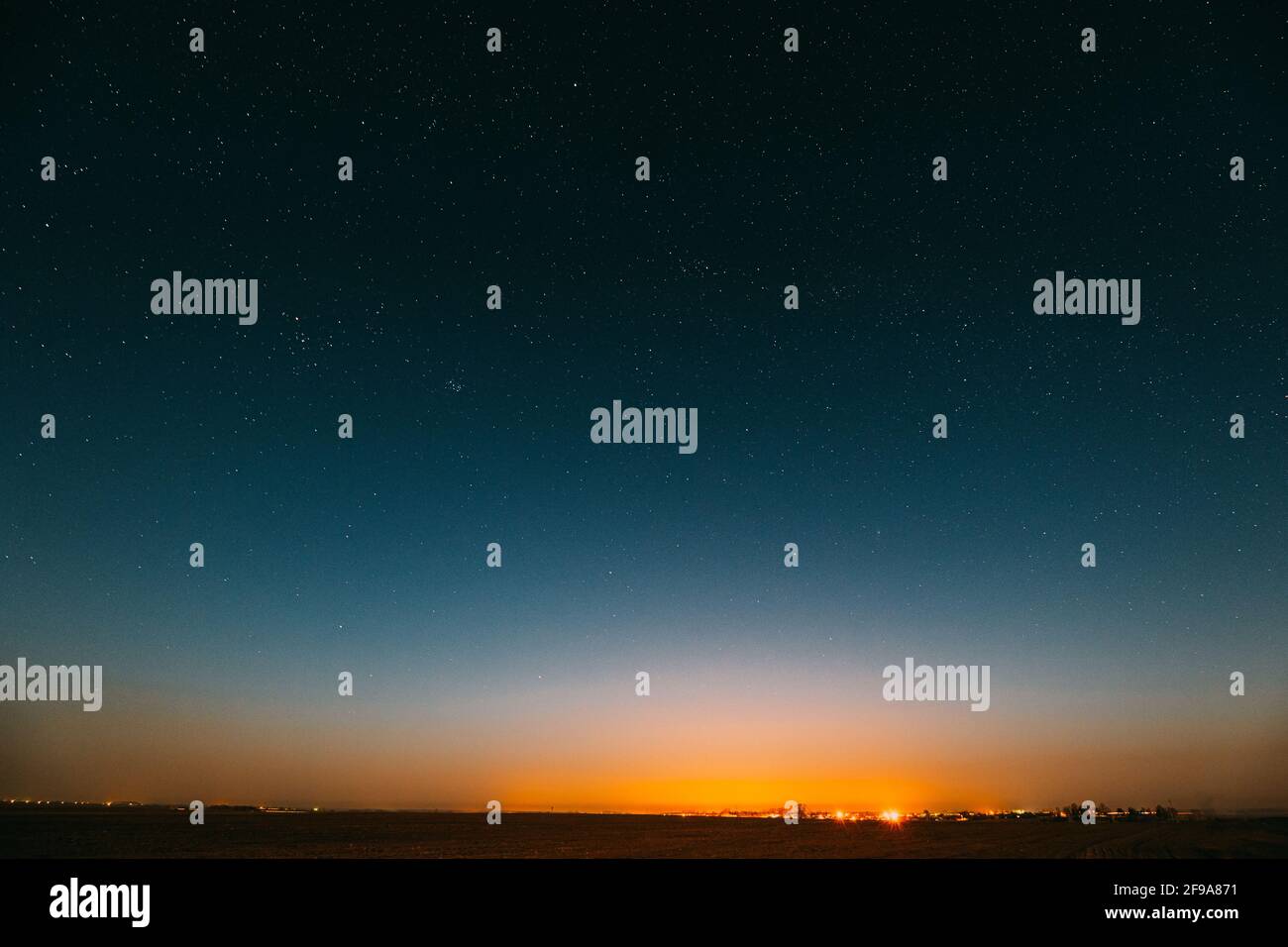 Night Starry Sky Over Yellow Sunset Or Sunrise Lights. Night Glowing ...