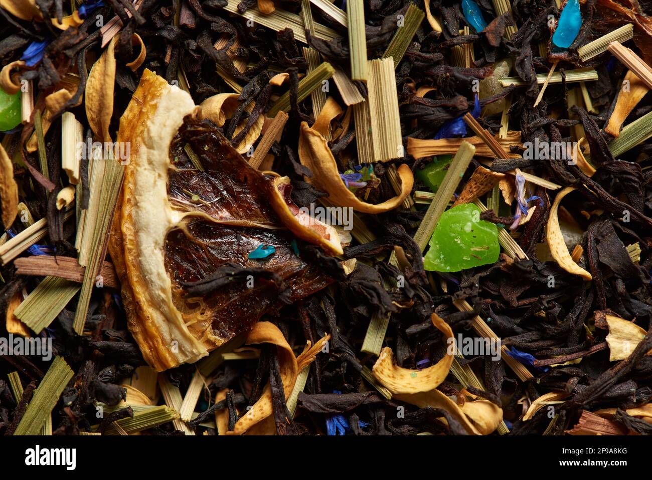 Mixed tea leaves with fruits as a background Stock Photo - Alamy