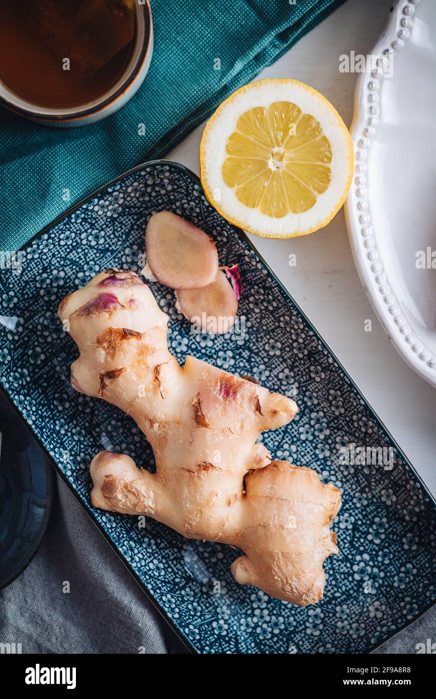 Healthy fresh raw ginger roots with lemon Stock Photo - Alamy