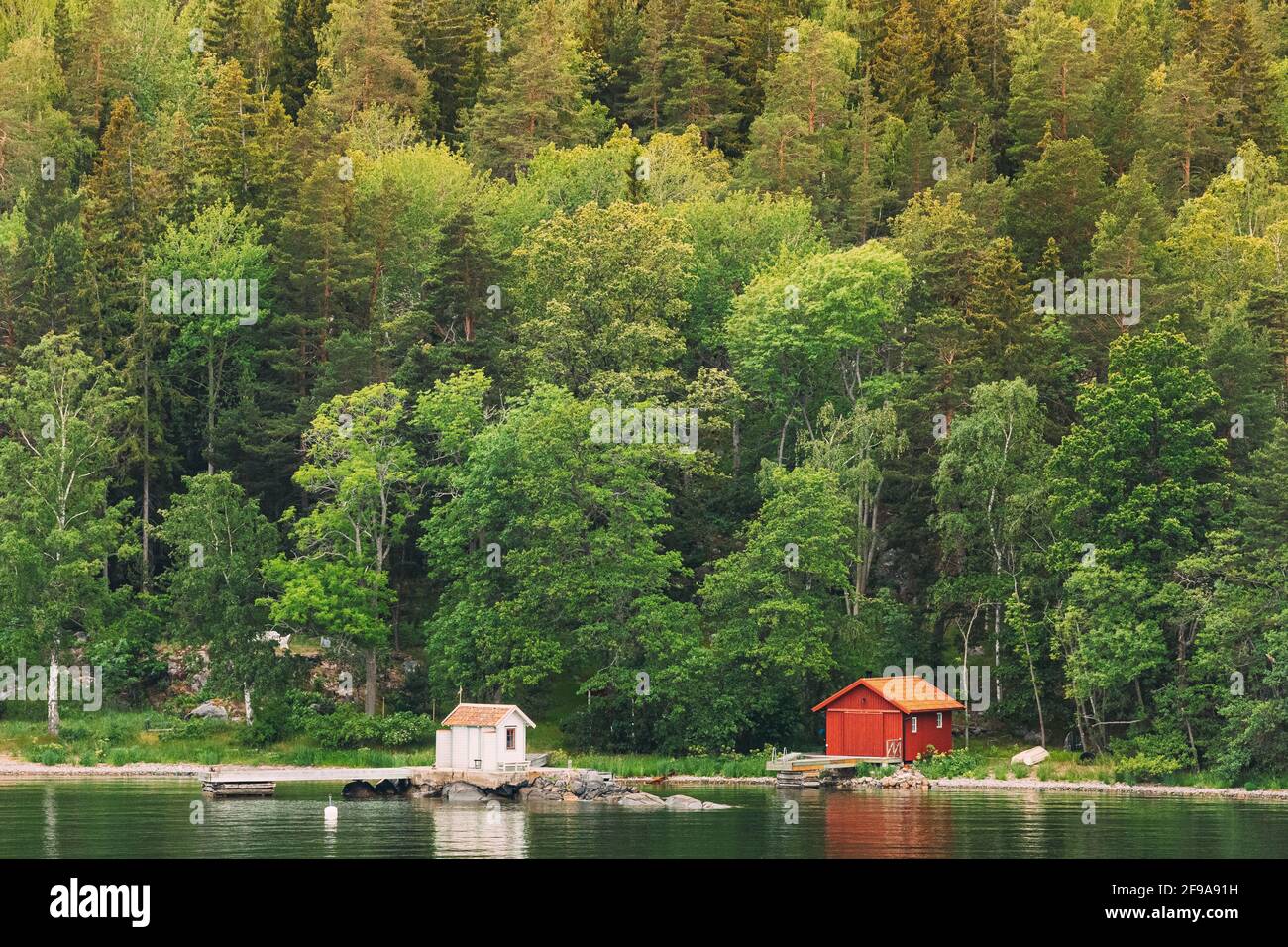 Sweden. Beautiful Red Swedish Wooden Log Cabin House On Rocky Island ...