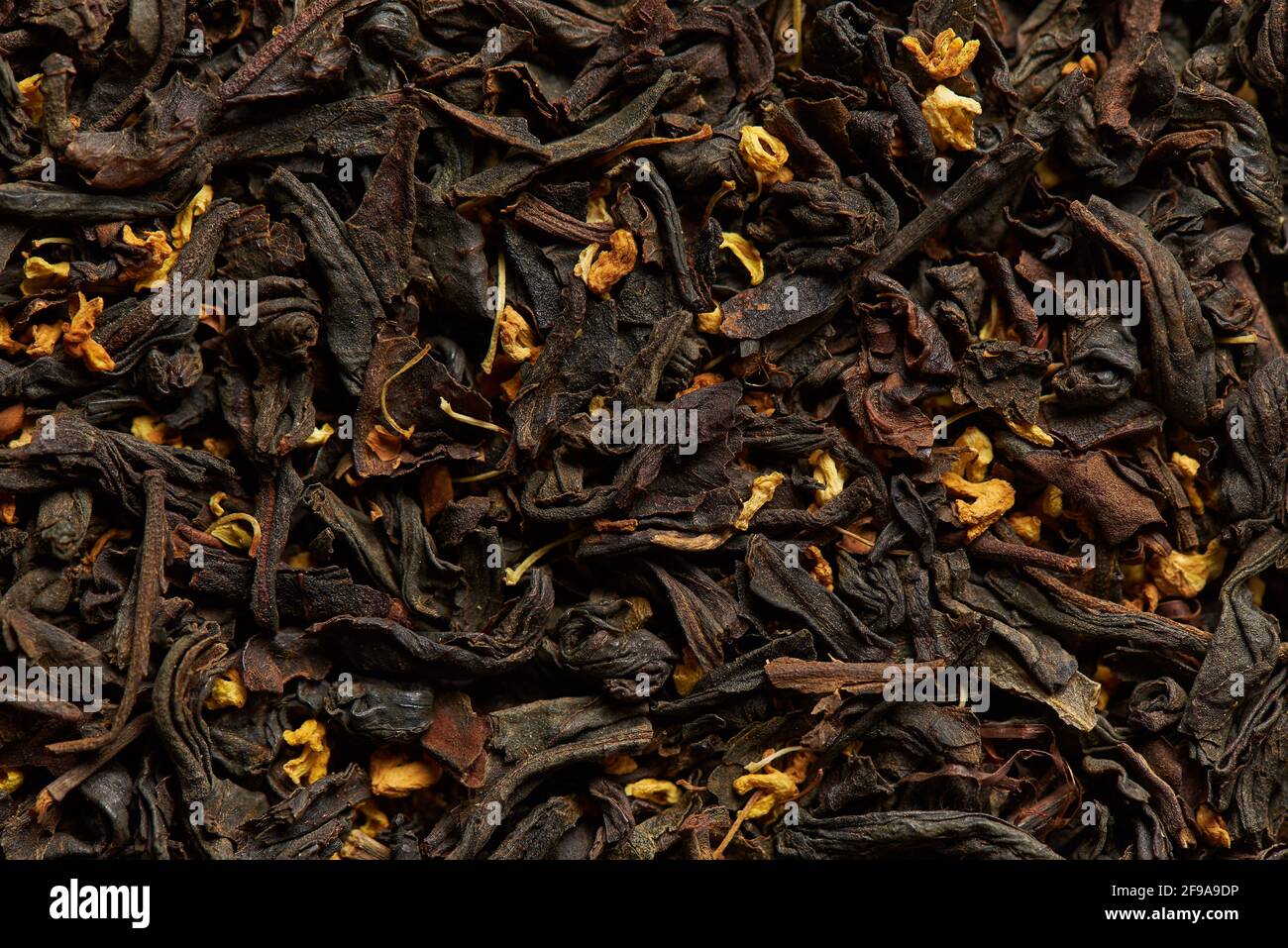 Tea leaves with flower petals as a background Stock Photo - Alamy