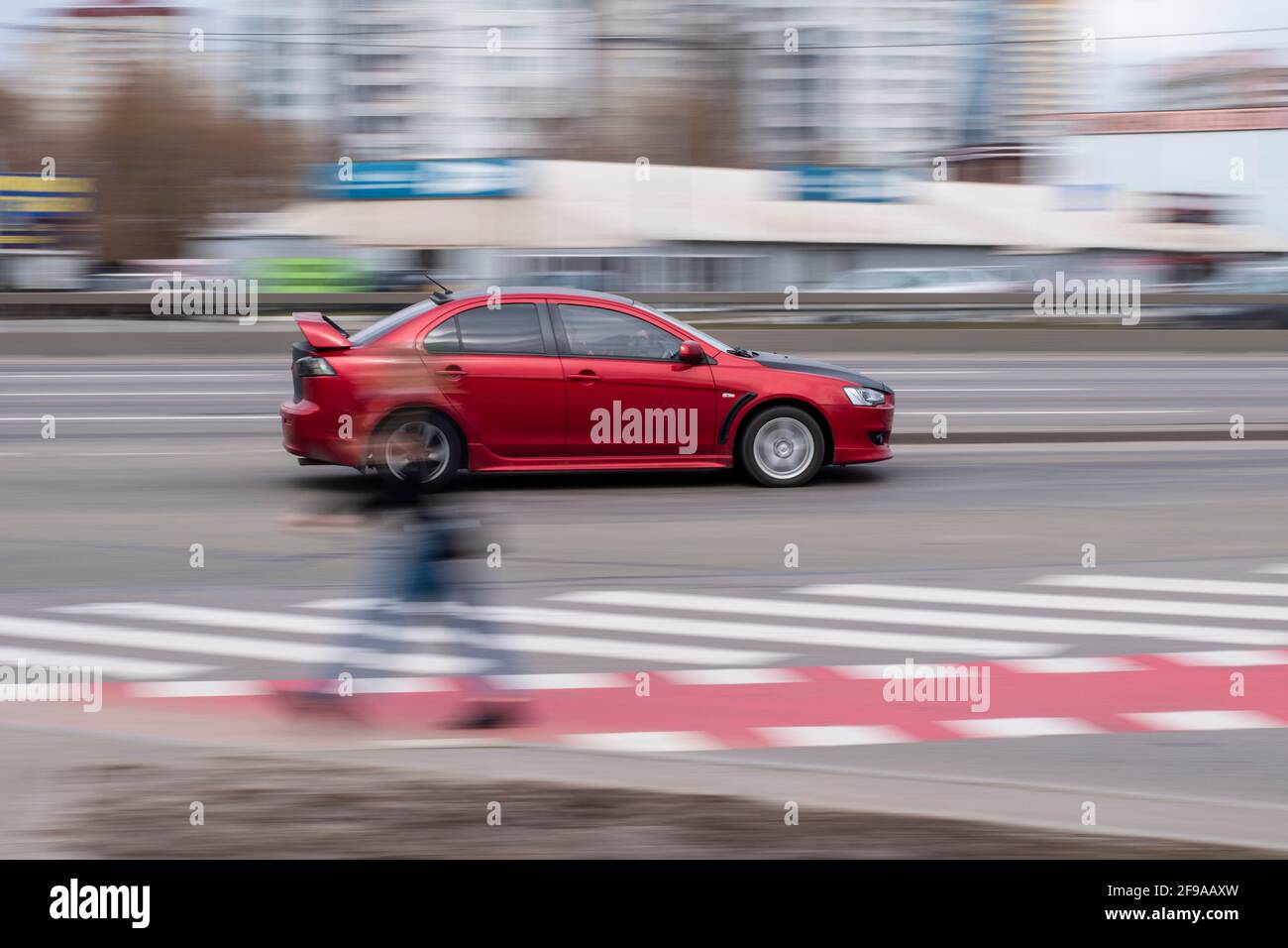 Ukraine, Kyiv - 18 March 2021: Red Mitsubishi Lancer car moving on the ...