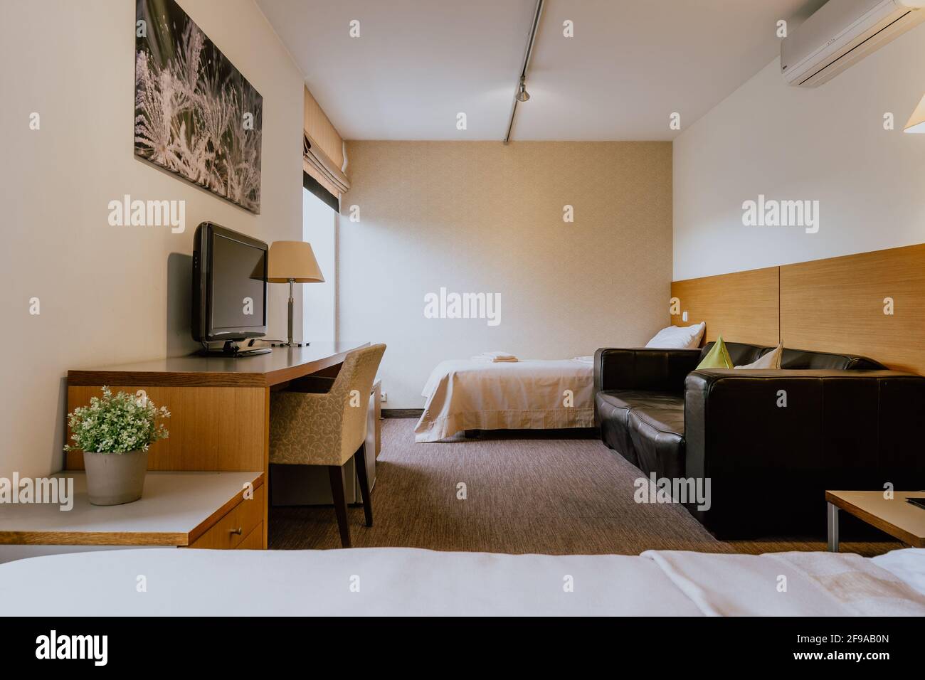 Cozy hotel bedroom with commodities Stock Photo - Alamy