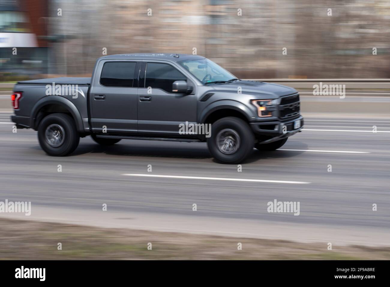 Ukraine, Kyiv - 18 March 2021: Gray Ford F-150 car moving on the street ...