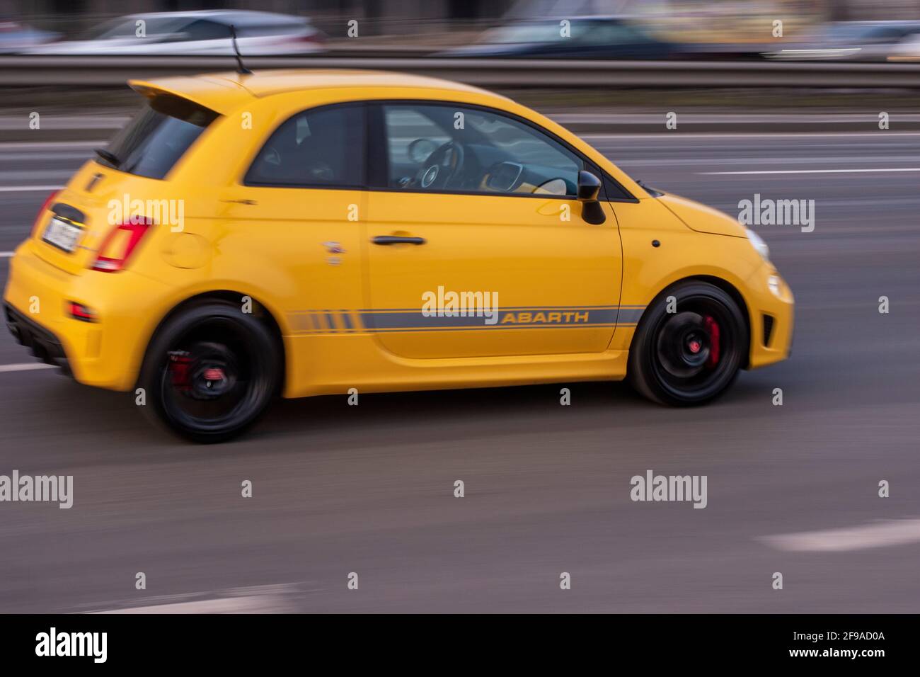 Ukraine, Kyiv - 11 March 2021: Yellow FIAT 500 car moving on the street ...